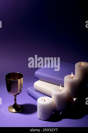 golden christian chalice with candles and purple background Stock Photo ...