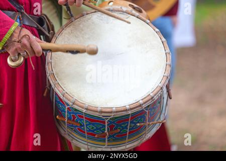 Medieval minstrel playing drum during the annual 'Médiévales' festival ...