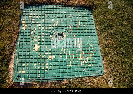 Old drain or water supply access cover on a pavement in the UK Stock ...