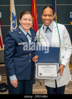 U.S. Coast Guard Lt. Alyse Westbrooks (center) graduated as physician assistant into the Pi ...