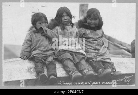Three Eskimo children seated side by side, between c1900 and c1930 ...