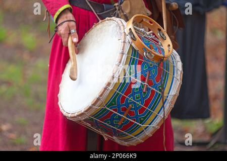 Medieval minstrel playing drum during the annual 'Médiévales' festival ...