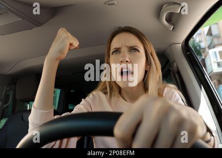 Stressed angry woman in driver's seat of modern car Stock Photo - Alamy