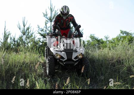 Man driving modern quad bike on sandy road. Extreme sport Stock Photo ...