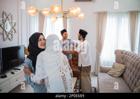 muslim family embracing during family eid mubarak celebration Stock ...