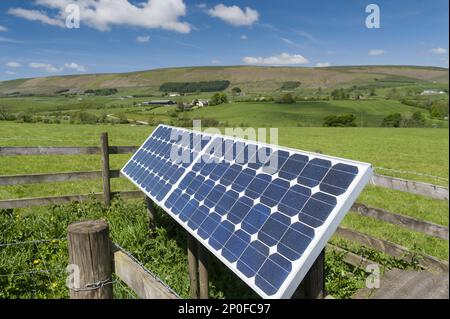 Solar panels operate on a farm near homes Wednesday, Jan. 14, 2026, in ...