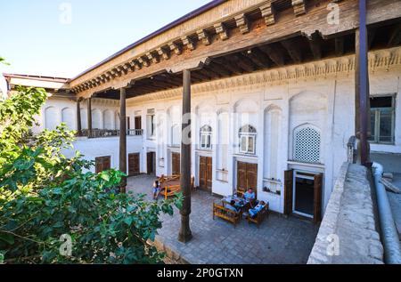 Double height porch, veranda carved wood column and ceiling detail. At ...