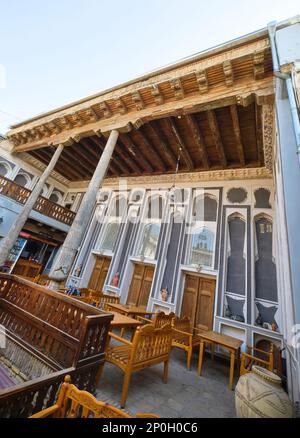 Double height porch, veranda carved wood column and ceiling detail. At ...