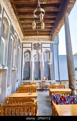 Double height porch, veranda carved wood column and ceiling detail. At ...
