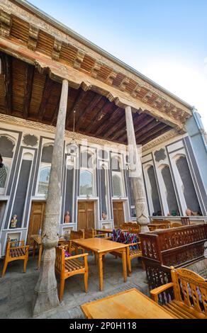 Double height porch, veranda carved wood column and ceiling detail. At ...