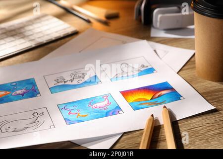 Storyboard with cartoon sketches at workplace. Pre-production process ...