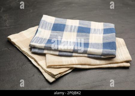 New kitchen towels with simple black pattern folded on marble counter ...