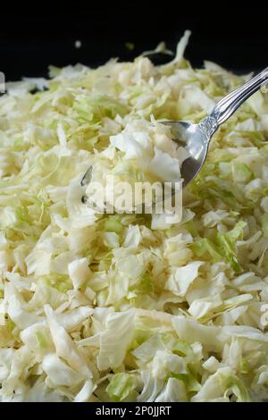 A pile of fresh green cabbage leaves, collected and stacked on the ...