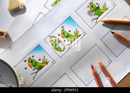 Storyboards with cartoon sketches at workplace, flat lay. Pre ...