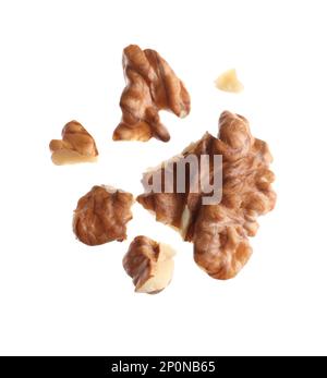 Pieces of walnut falling on white background Stock Photo - Alamy
