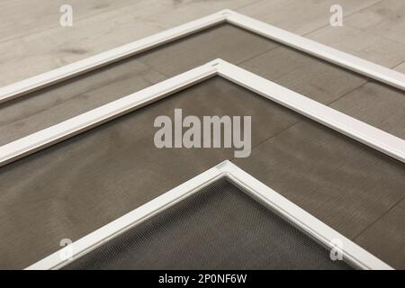 Set of window screens on wooden floor, flat lay. Space for text Stock ...