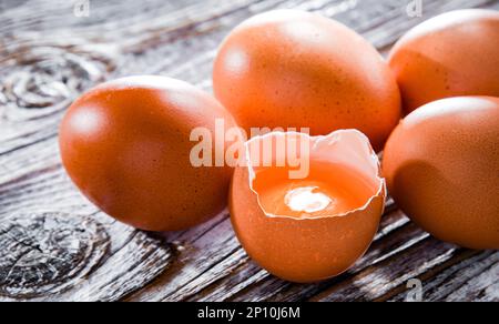 Composition with five chicken eggs on a wooden table Stock Photo - Alamy