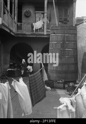 Courtyard with cistern and hanging laundry, New Orleans, between 1920 ...