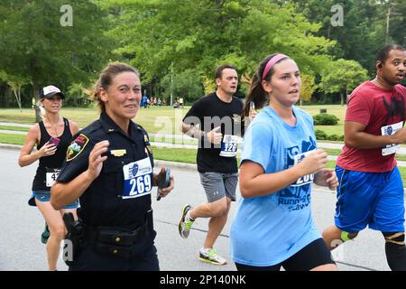 Jacksonville Police Officer Staci Leyble, left, runs in her full ...