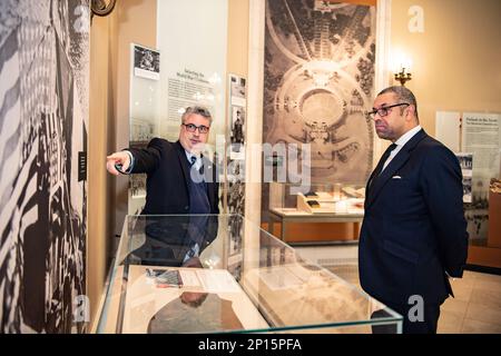 Rod Gainer (left), curator, Arlington National Cemetery, gives a tour ...
