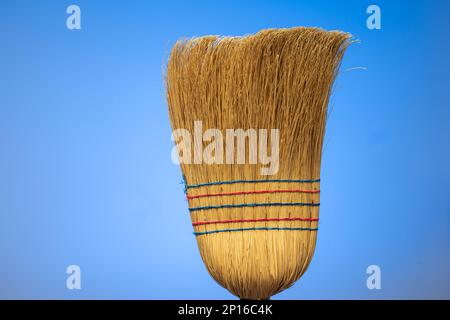 Braided broom close up detail shot isolated on blue background Stock ...