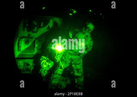 51st Security Police Squadron member SSGT Robert Colyer packs a white ...