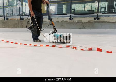 Worker welding pvc membrane by heater with welder machine Stock Photo ...