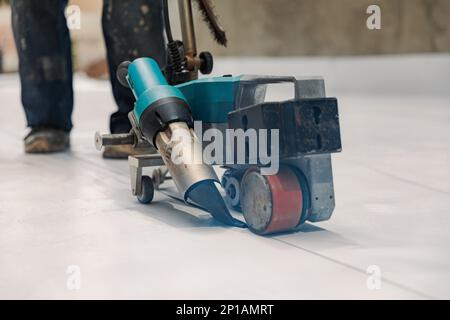 Worker welding pvc membrane by heater with welder machine Stock Photo ...
