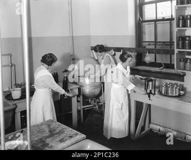 A team of people preparing fruit preserves with canning methods in a ...