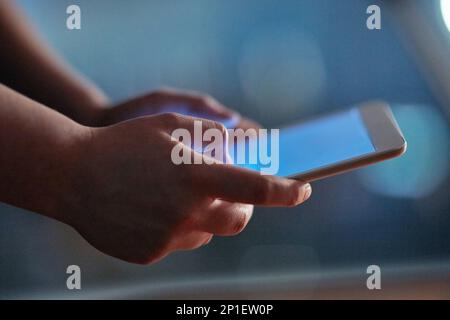 Activating night mode. Cropped shot of a woman using a digital tablet ...