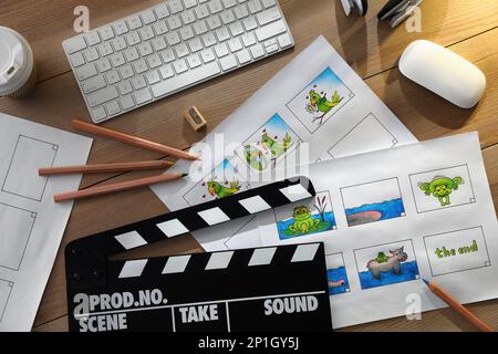 Storyboard with cartoon sketches at workplace, flat lay. Pre-production ...