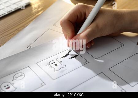 Woman drawing cartoon sketches at workplace, closeup. Pre-production ...