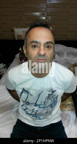 In this image released by the Honduras National Police, officers guard Franco Daniel Lombardi ...