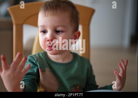 Cute little toddler smeared with chocolate around his mouth Stock Photo ...