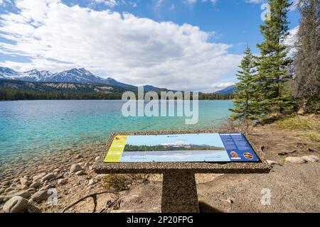 Lake Annette lake shore beach, Pyramid mountain reflection on the lake ...