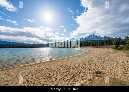 Lake Annette lake shore beach, Pyramid mountain reflection on the lake ...