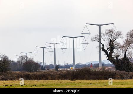 Line of T pylons under construction Stock Photo - Alamy