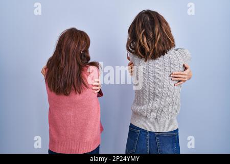 Hispanic mother and daughter together backwards thinking about doubt ...