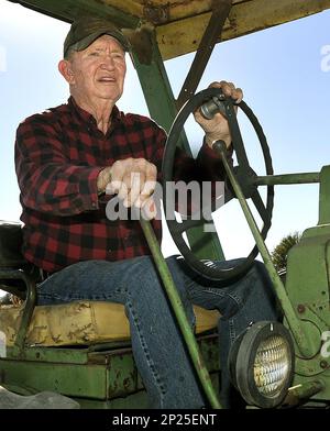 Vintage 1930s John Deere tractor in front of traditional Mennonite ...
