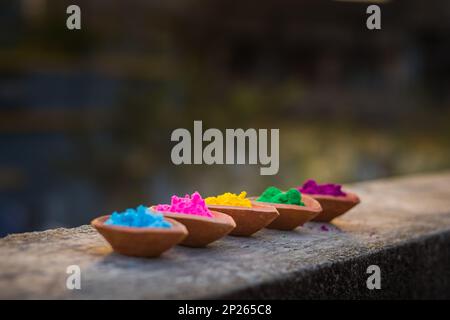 happy holi. gullal or abir, which are colorful powders for holi kept on ...