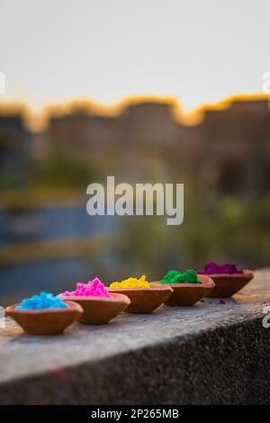 happy holi. gullal or abir, which are colorful powders for holi kept on ...
