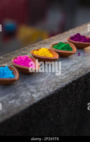 happy holi. gullal or abir, which are colorful powders for holi kept on ...