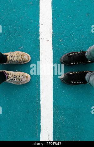 Two people separated by a white line. Separation, border Stock Photo ...