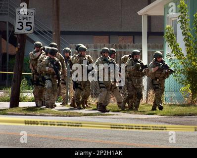 Unified Police SWAT officers get a view of the house off camera to the ...