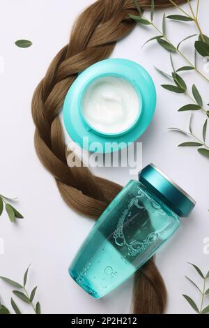 Natural cosmetic products, green leaves and hair braid on white ...