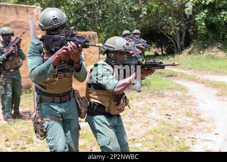 Ivorian Special Forces Soldiers execute tactical movements through a ...