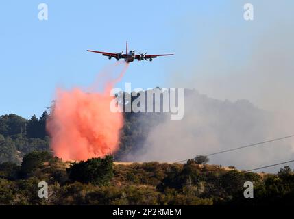 24 June 2015: A fixed wing aircraft makes a Phos-Chek drop on a ridge ...