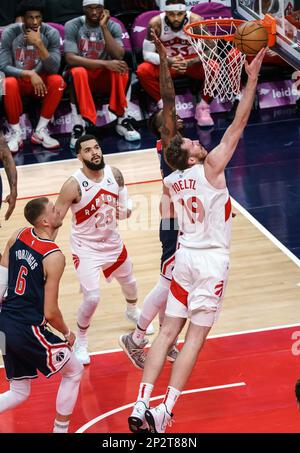 Toronto Raptors center Jakob Poeltl, left, tries to get a basket over ...