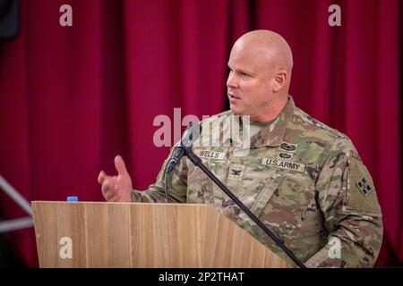 Col. Damon Wells, commander of 4th Infantry Division Artillery, hands over the battalion colors ...