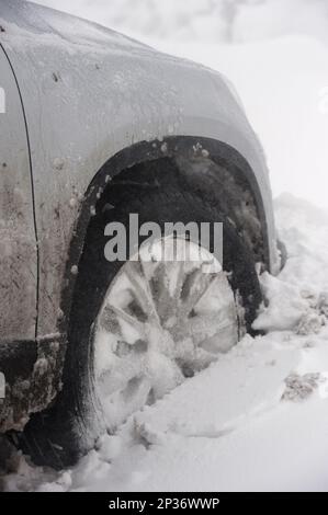 A car wheel stuck in a snowdrift. Closeup photo Stock Photo - Alamy